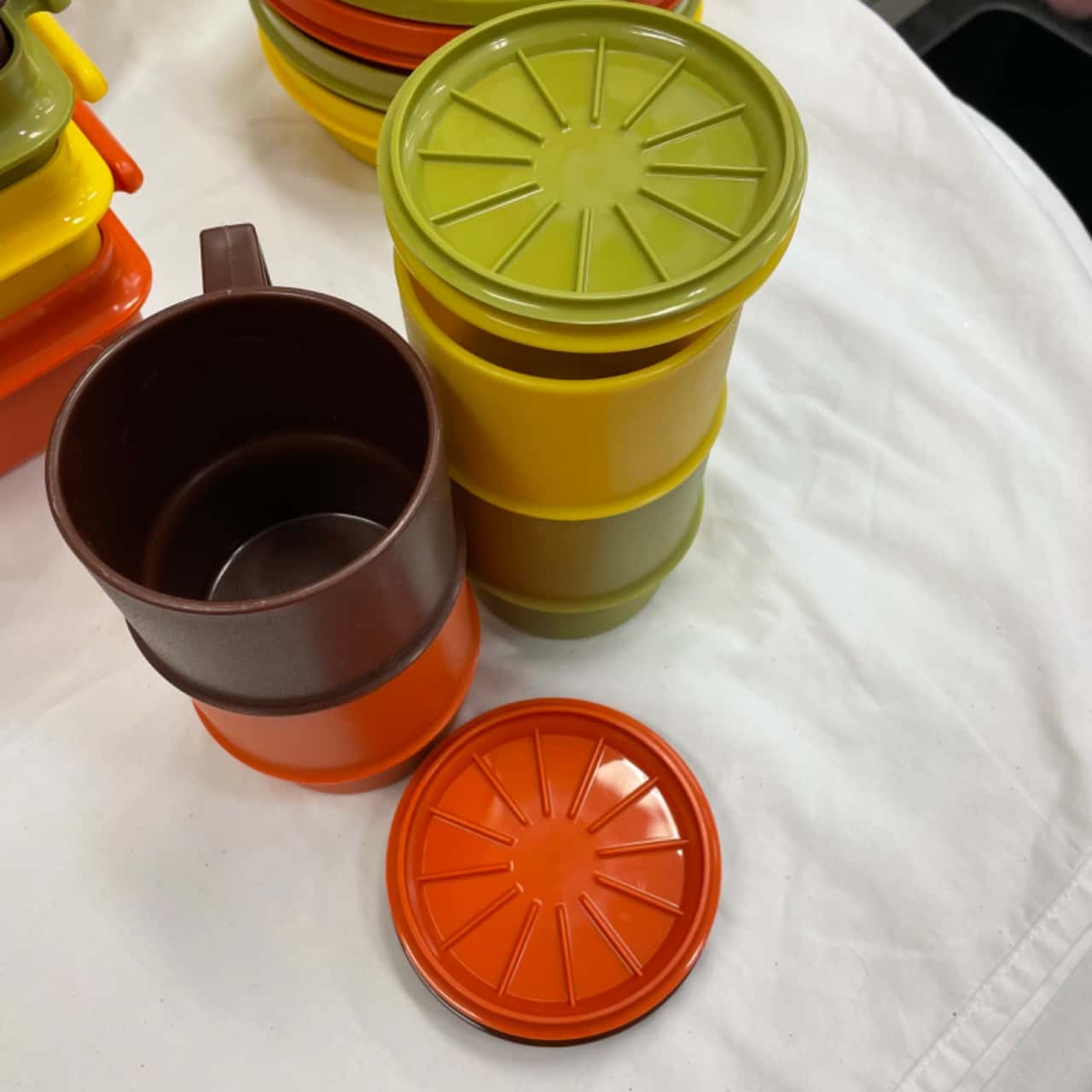 Tupperware boxes, bowls and cups all with lids(s)