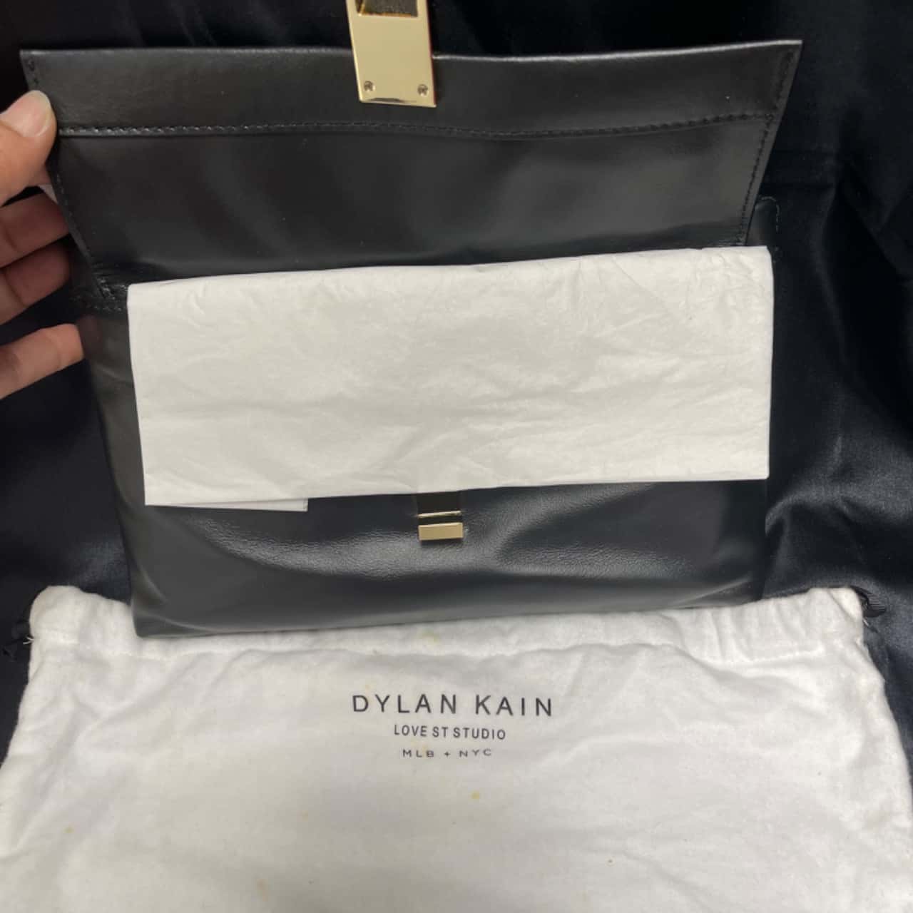 Dylan Kain, Black Leather Clutch (s)