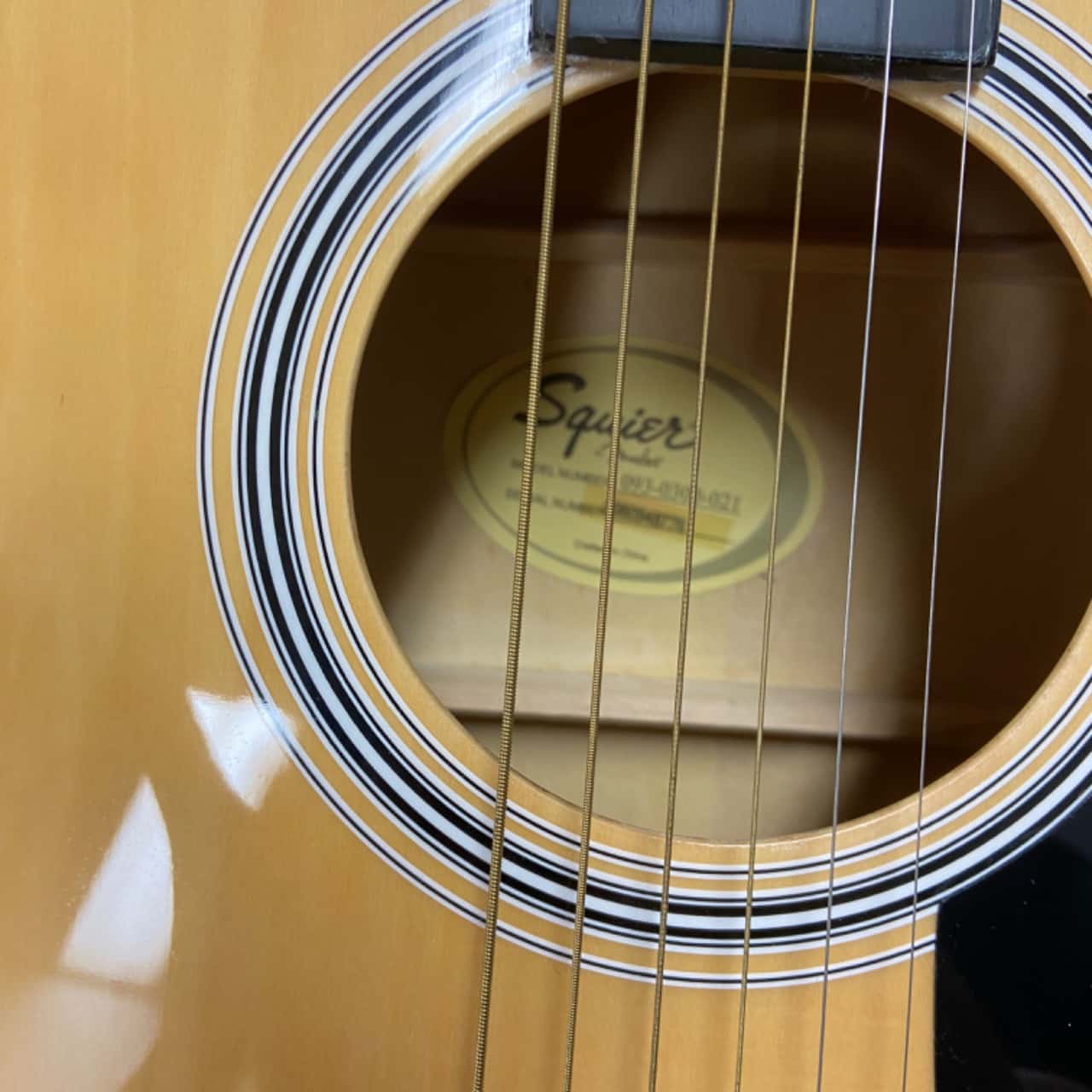 Squire by Fender guitar with books, picks and tuner