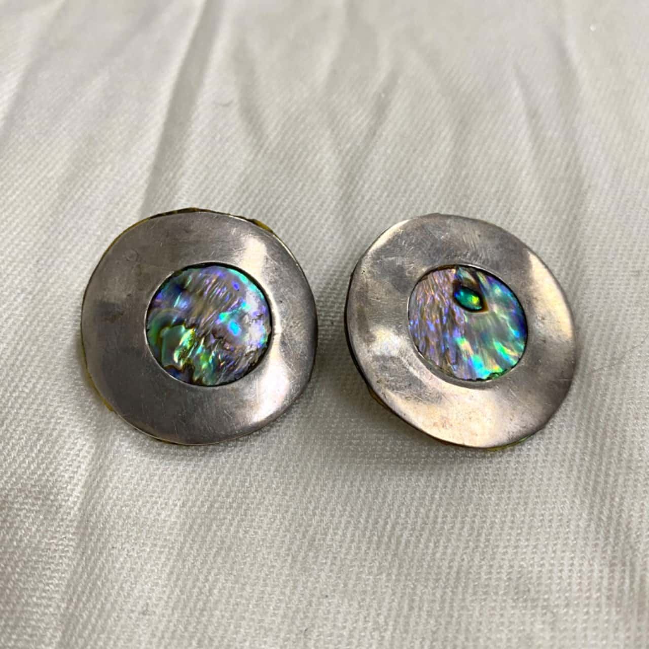 Unique Paua shell earrings framed in round silver-toned metal(s)
