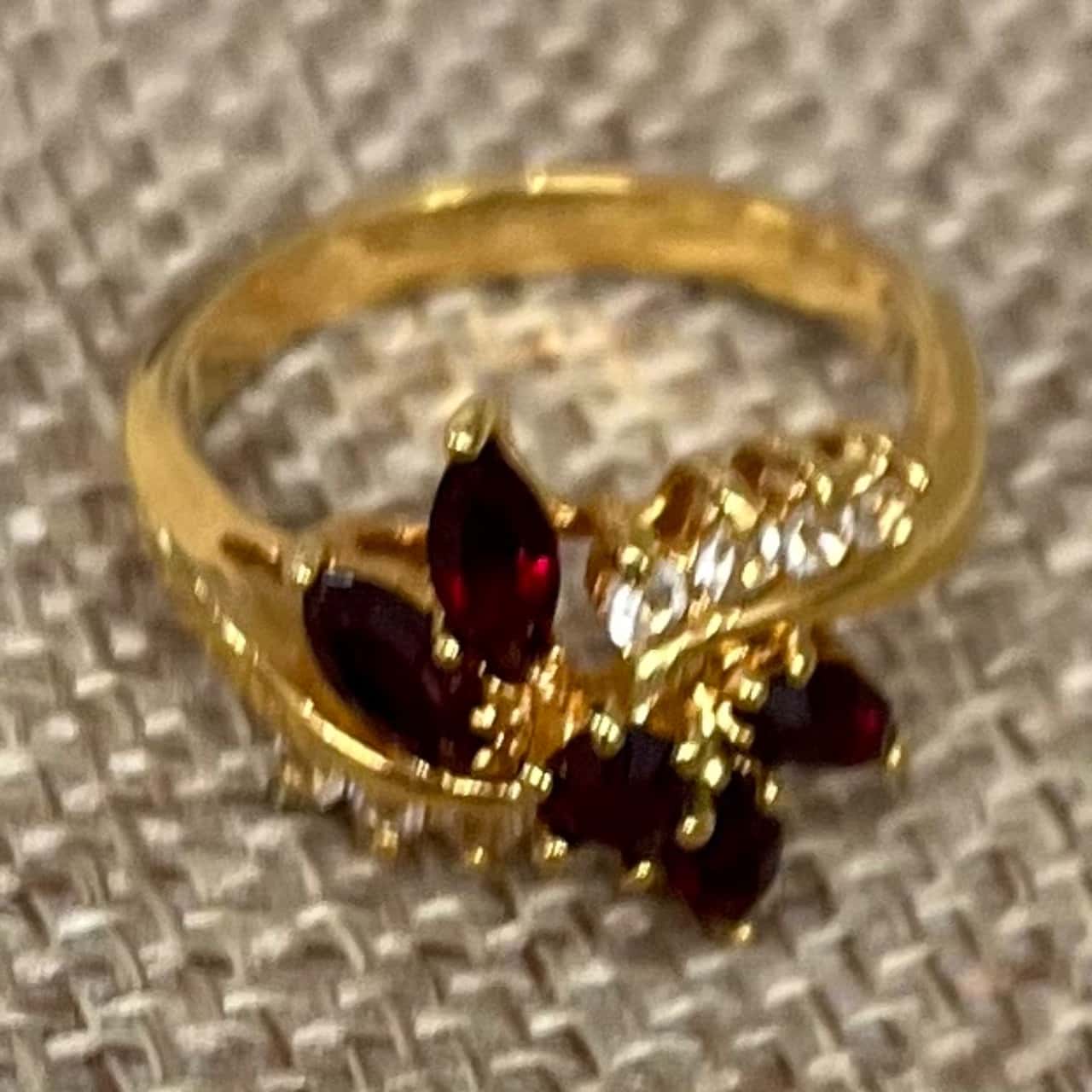 Gold ring with Ruby coloured Stones (s)