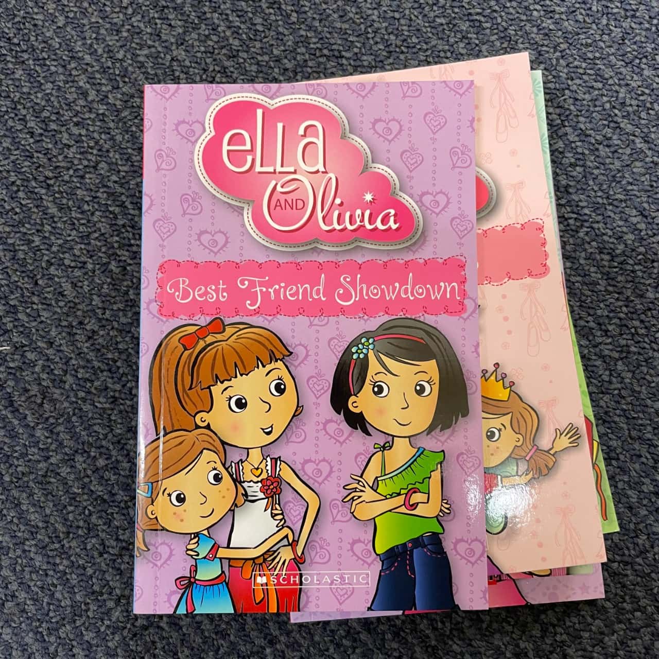 Ella and Olivia. 8 soft cover books in cardboard case. Good condition(s)
